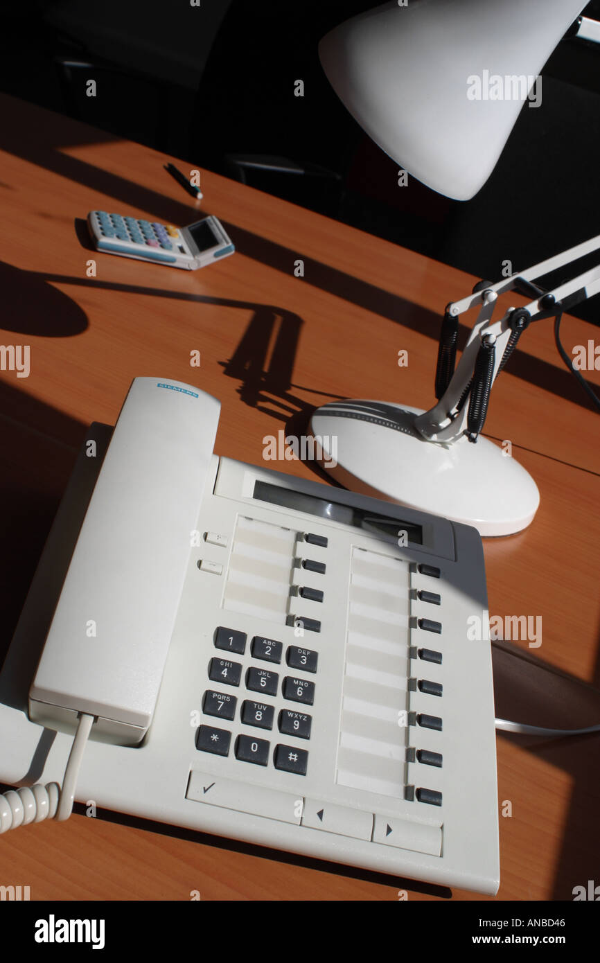 Modern office furniture telephone handset angle lamp on wooden desk ...