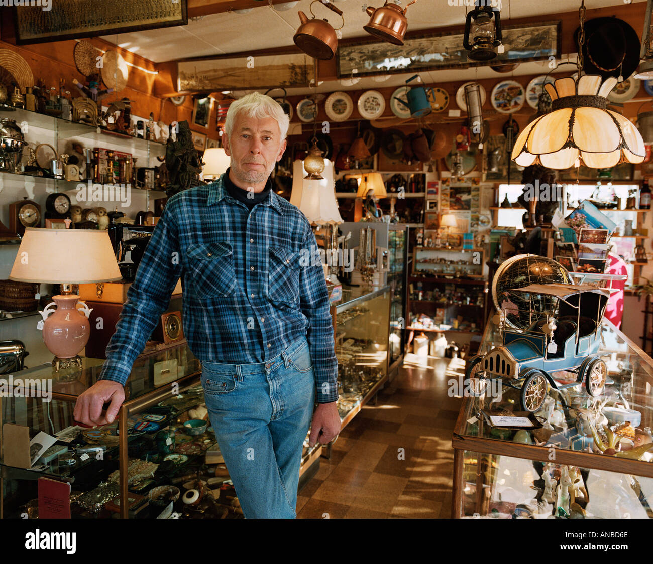 Portrait of an Antique dealer owner inside his store Stock Photo - Alamy