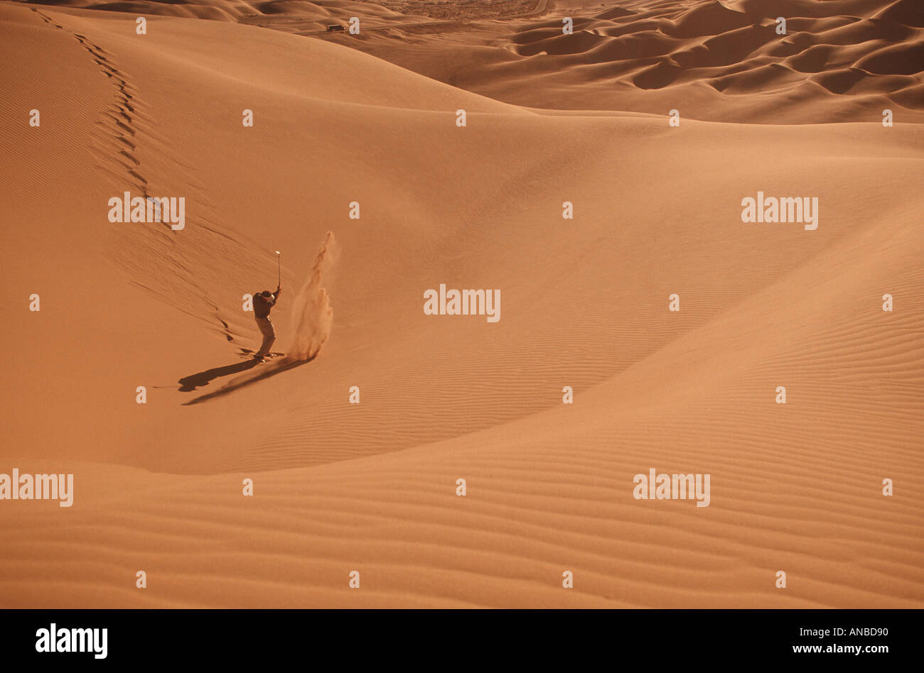 The ultimate sand trap Golfer hitting ball in the sand dunes Stock ...