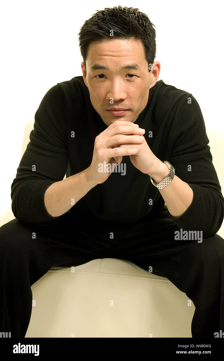 Young Professional Sitting with Folded hands Stock Photo - Alamy
