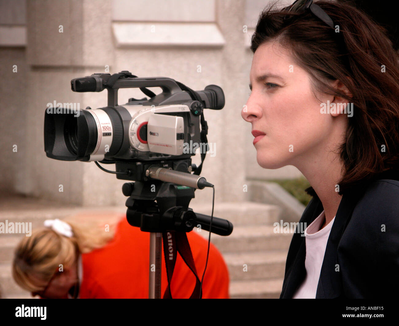 Young real Woman News cameraman covering speech acting as reporter with ...