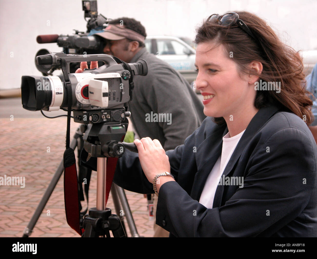 Young real Woman News cameraman covering speech acting as reporter with ...