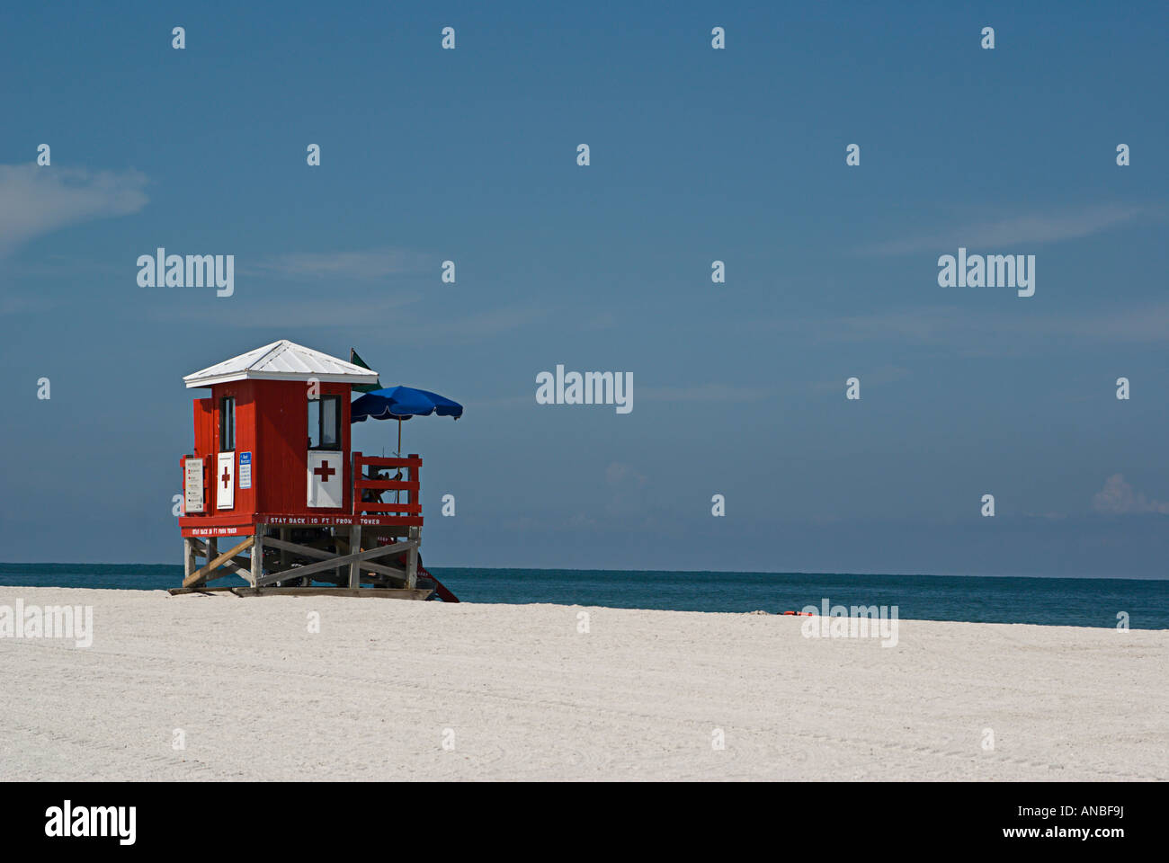 A lifeguard in his tower, watching over the quiet morning ocean at Sand ...