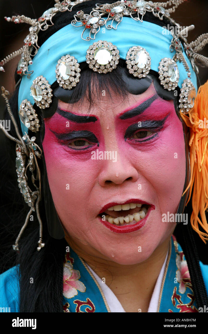 A female Chinese opera singer concentrates hard on her outdoor ...