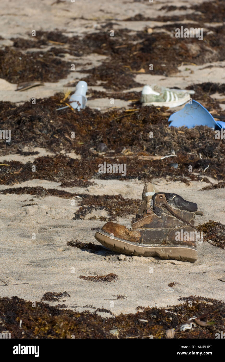 garbage trash rubbish waste washed up on beach in seaweed ocean coastal ...
