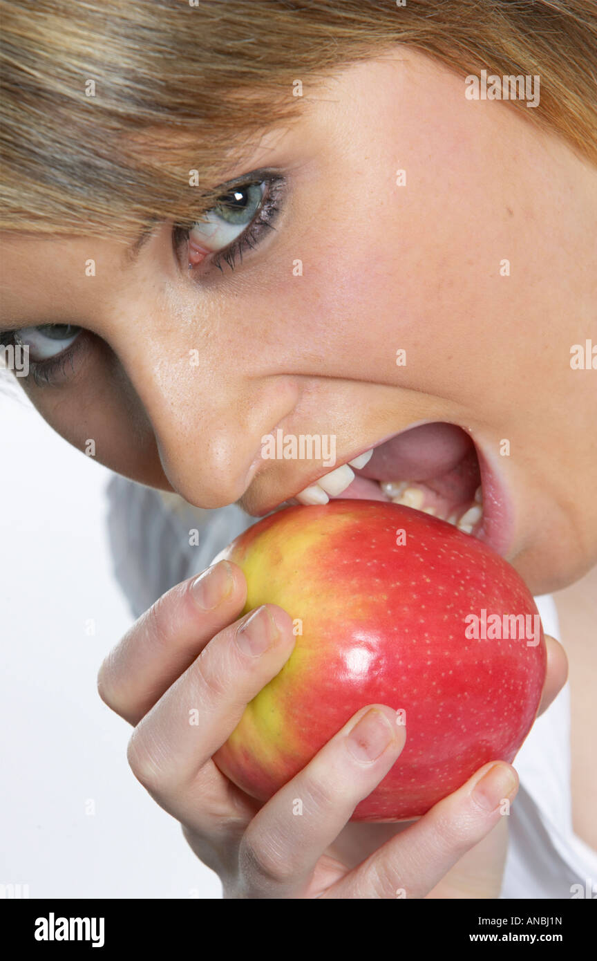 Young Woman Biting an Apple Closeup Stock Photo - Alamy