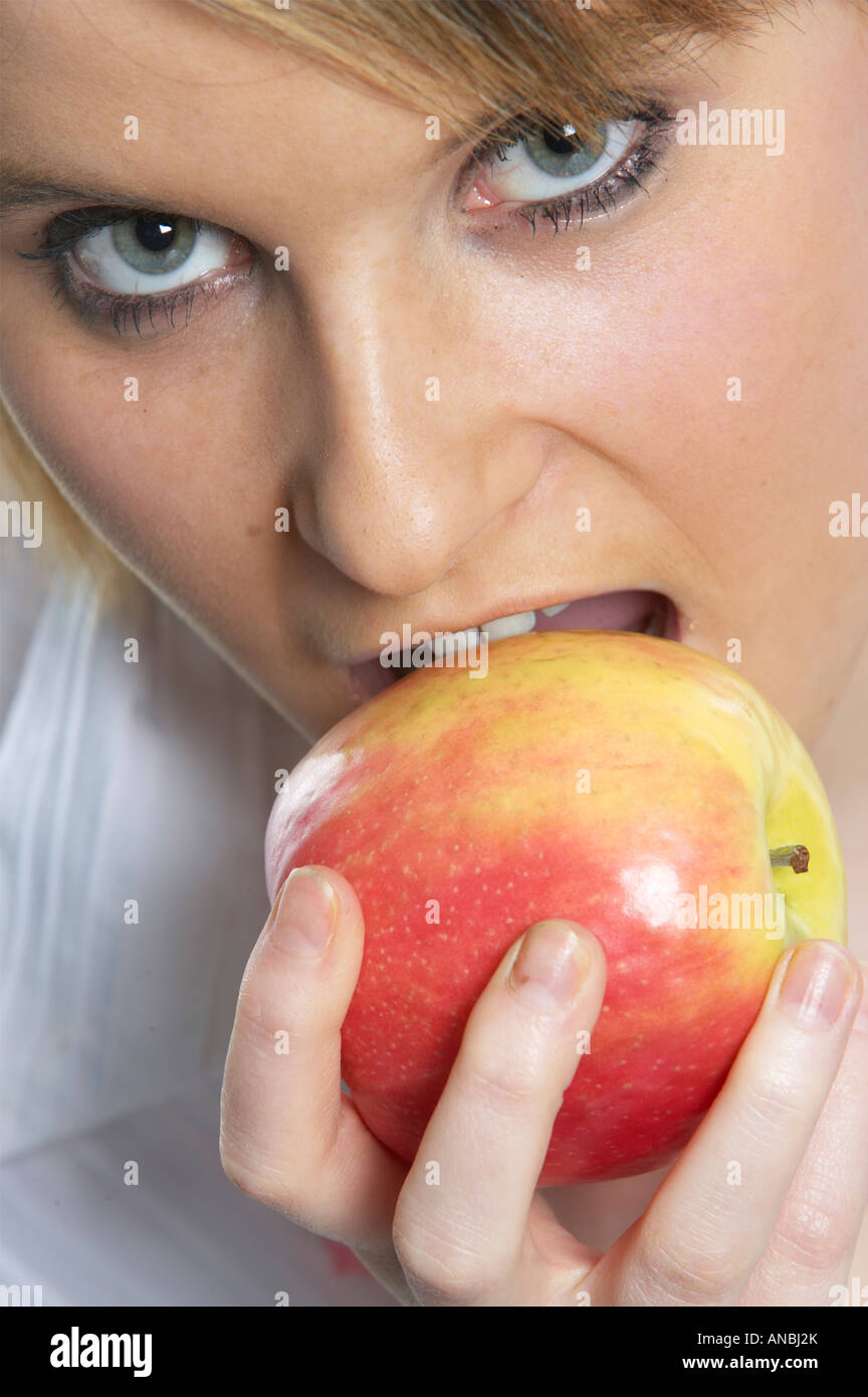 Young Woman Biting an Apple Closeup Stock Photo - Alamy