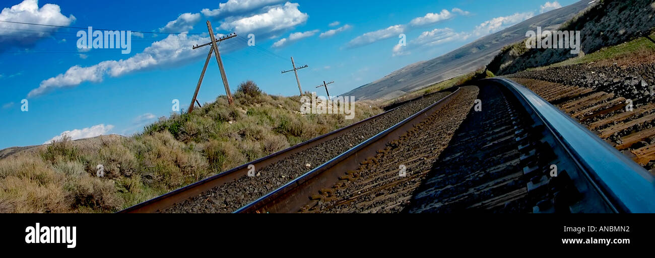Ground level shot of train tracks curving into the distance Stock Photo ...