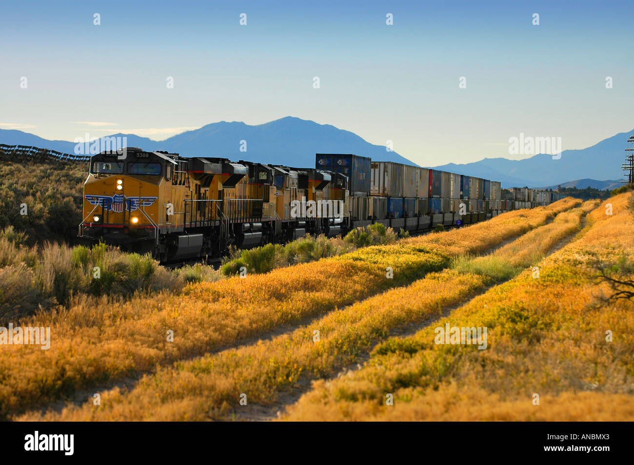 Train moves down the railroad pulling freight cars and boxcars Stock ...