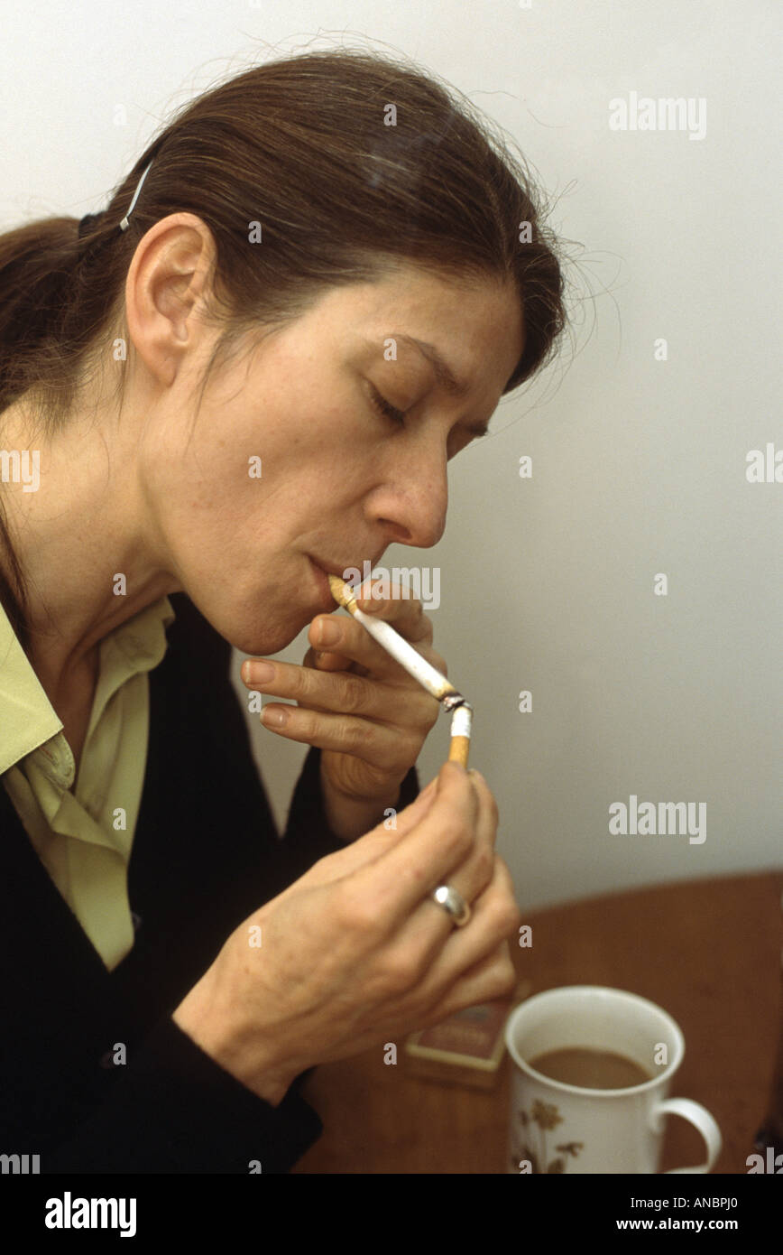 Woman chain smoking hi-res stock photography and images - Alamy