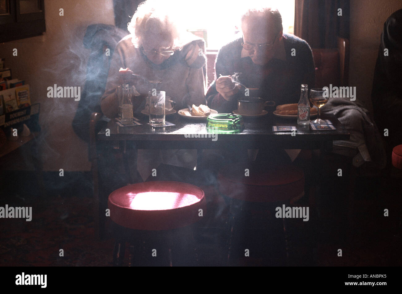 old couple eating a meal in a smokey pub Stock Photo - Alamy