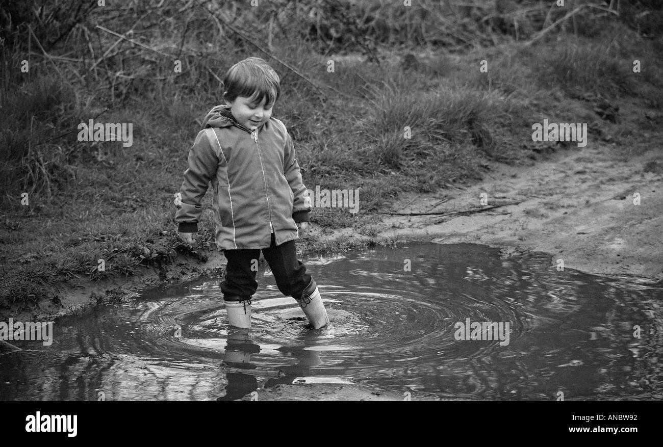 Boy puddle splashing Black and White Stock Photos & Images - Alamy