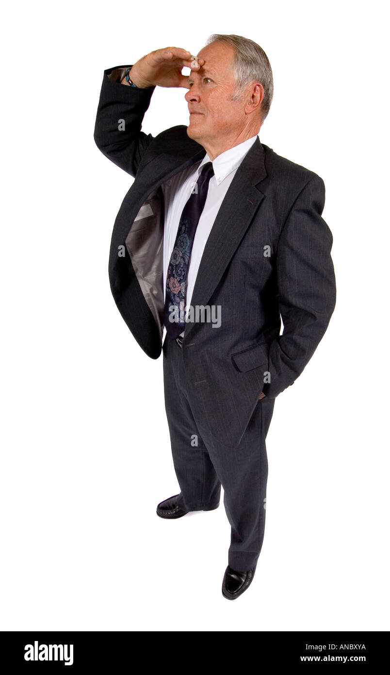 Medium shot of an executive looking off camera shading his eyes with ...