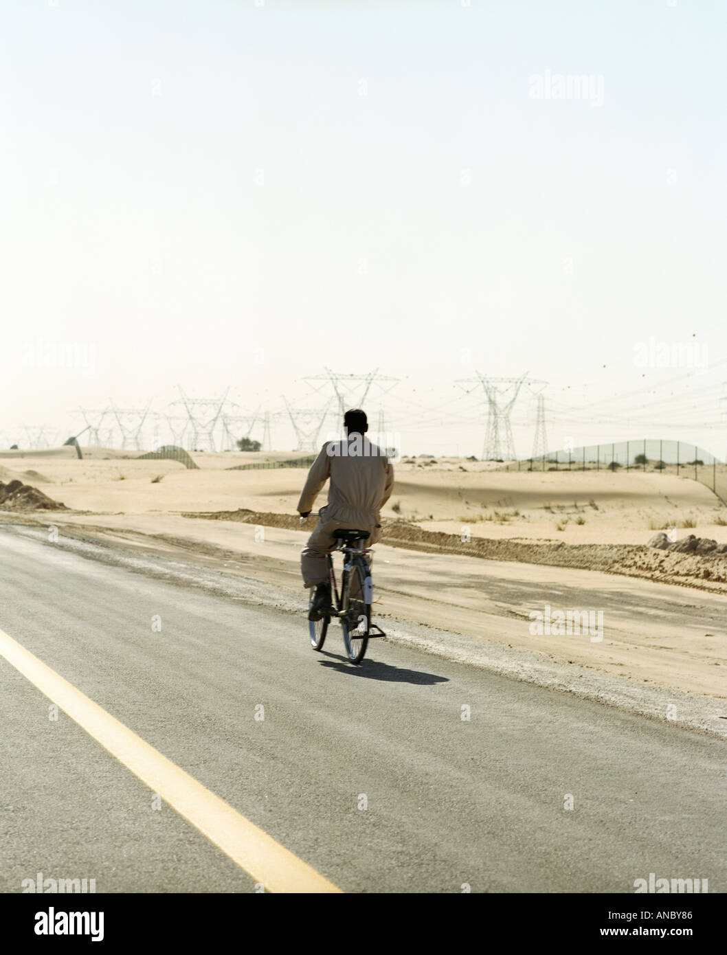 worker cycling along highway Stock Photo - Alamy