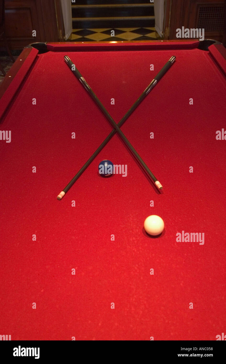Red Pool Table with Sticks and Cue Balls Stock Photo - Alamy