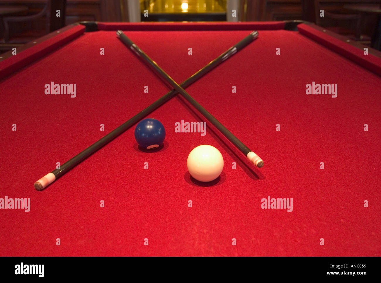 Red Pool Table with Sticks and Cue Balls Stock Photo - Alamy