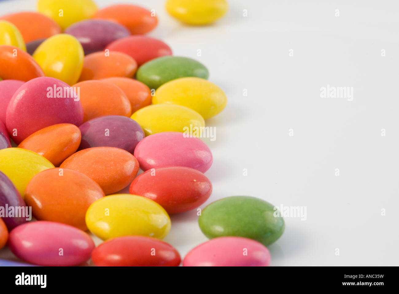 Close up background of multi colored smarties candy Stock Photo - Alamy