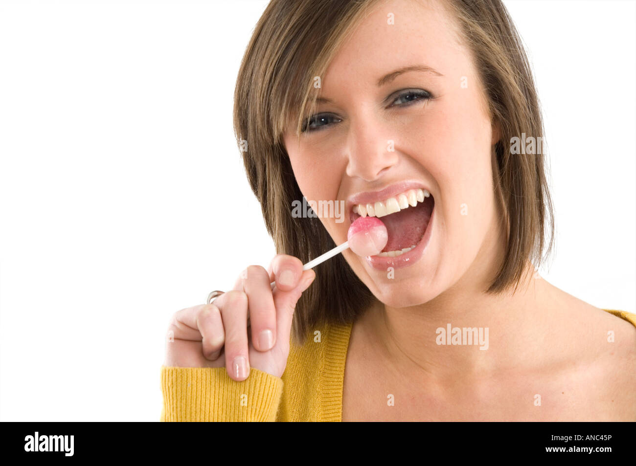 woman with perfect white teeth biting a lollypop Stock Photo - Alamy