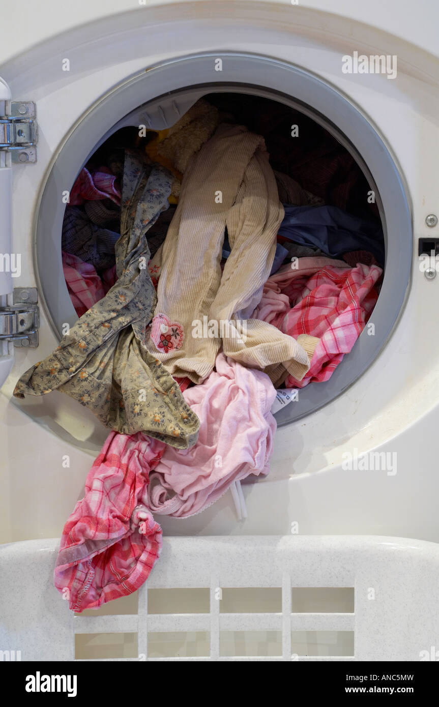 Laundry spilling from washing machine Stock Photo - Alamy