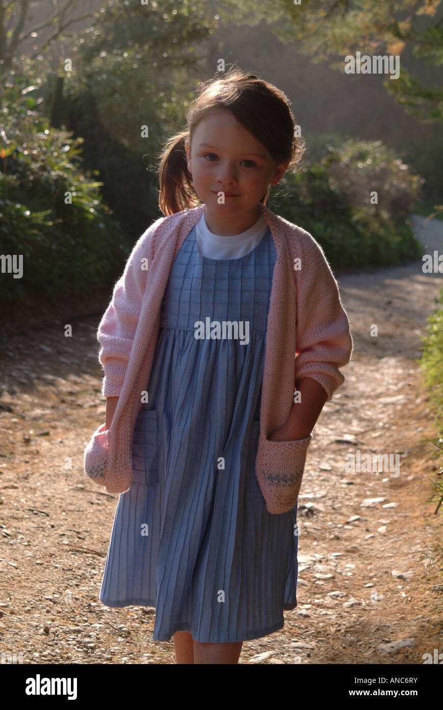 Portrait of a little girl walking in the countryside Stock Photo - Alamy