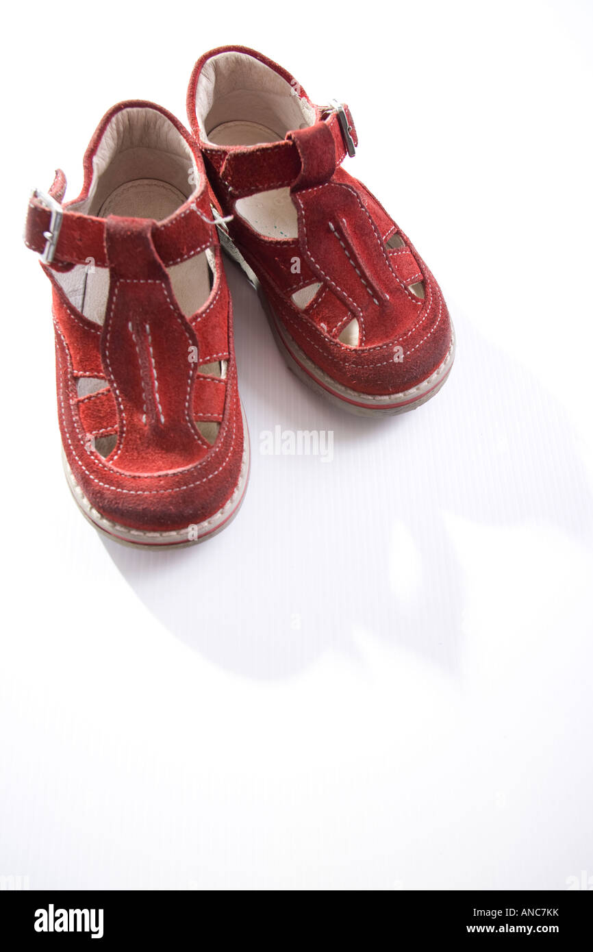 Baby first steps red leather shoes Stock Photo - Alamy