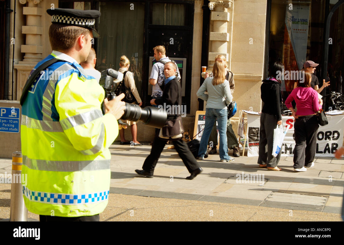 Uniformed police officer using a digital camera to photograph animal ...