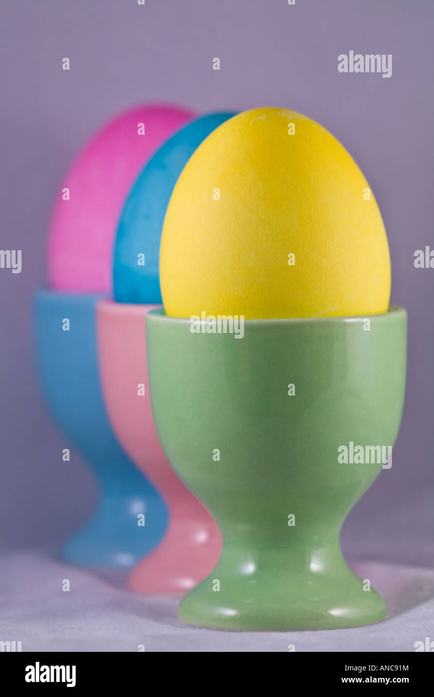 Three Easter eggs in egg cups lined up Stock Photo - Alamy