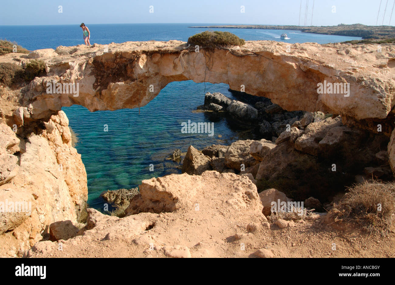 Natural arch bridge caused by wave action of sea eroding rock at Cape ...