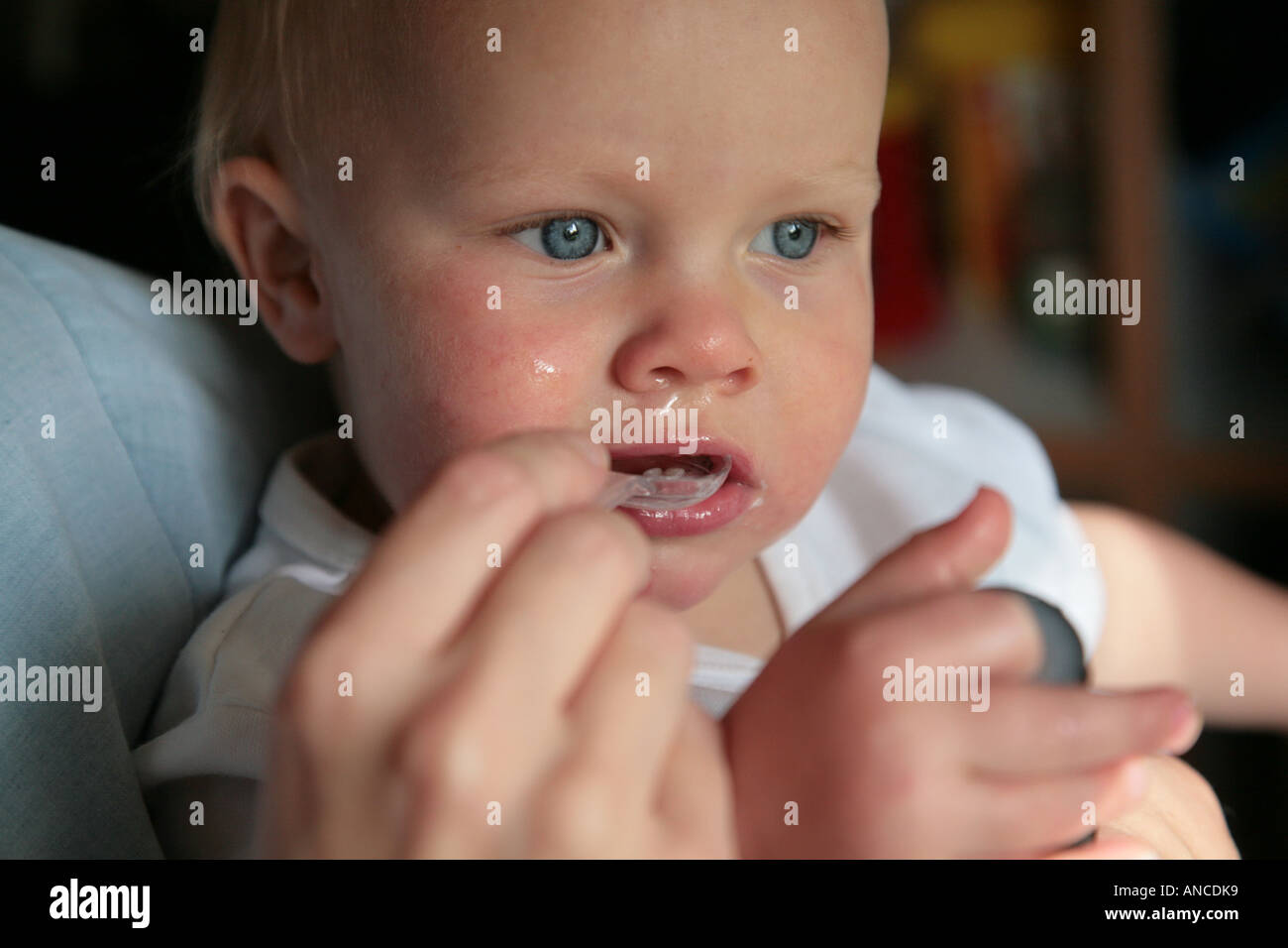 baby being given spoonful of medicine Stock Photo - Alamy