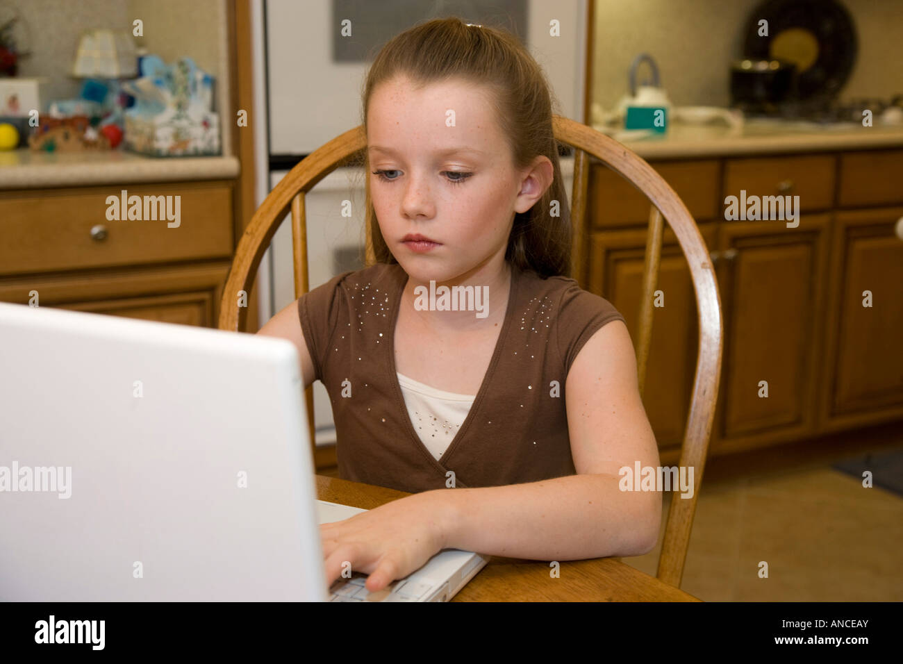 young girl working on a lap top computer age 9 12yrs Stock Photo - Alamy