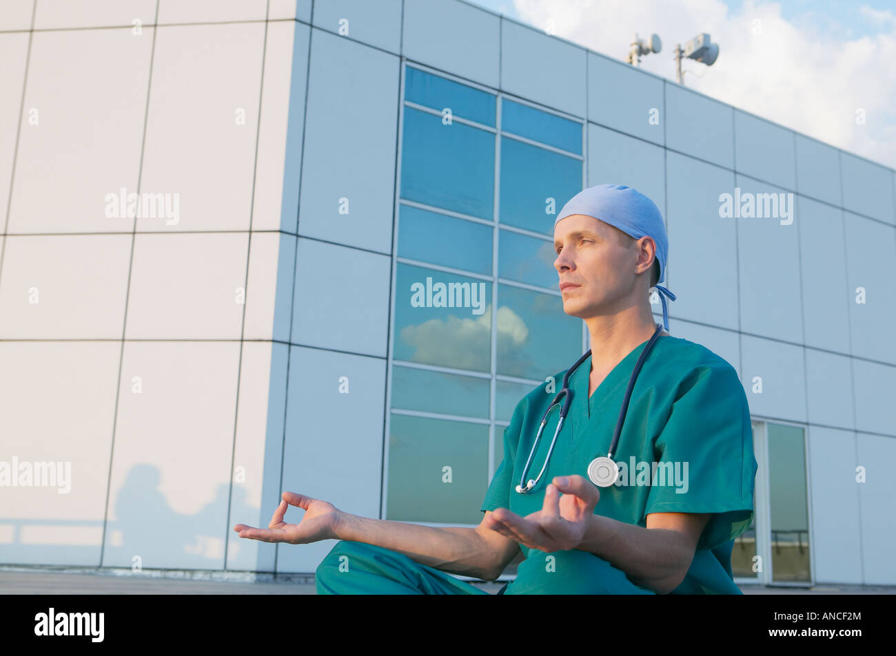 Male doctor meditating Stock Photo - Alamy