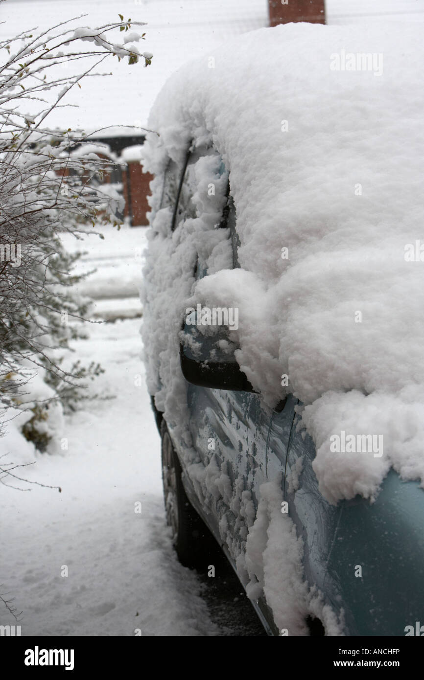 snow covering roof and windscreen of car parked in driveway after heavy ...