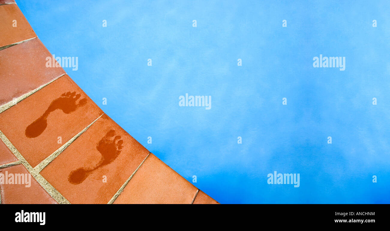 Footprints on the edge of a swimming pool during a summer holiday ...