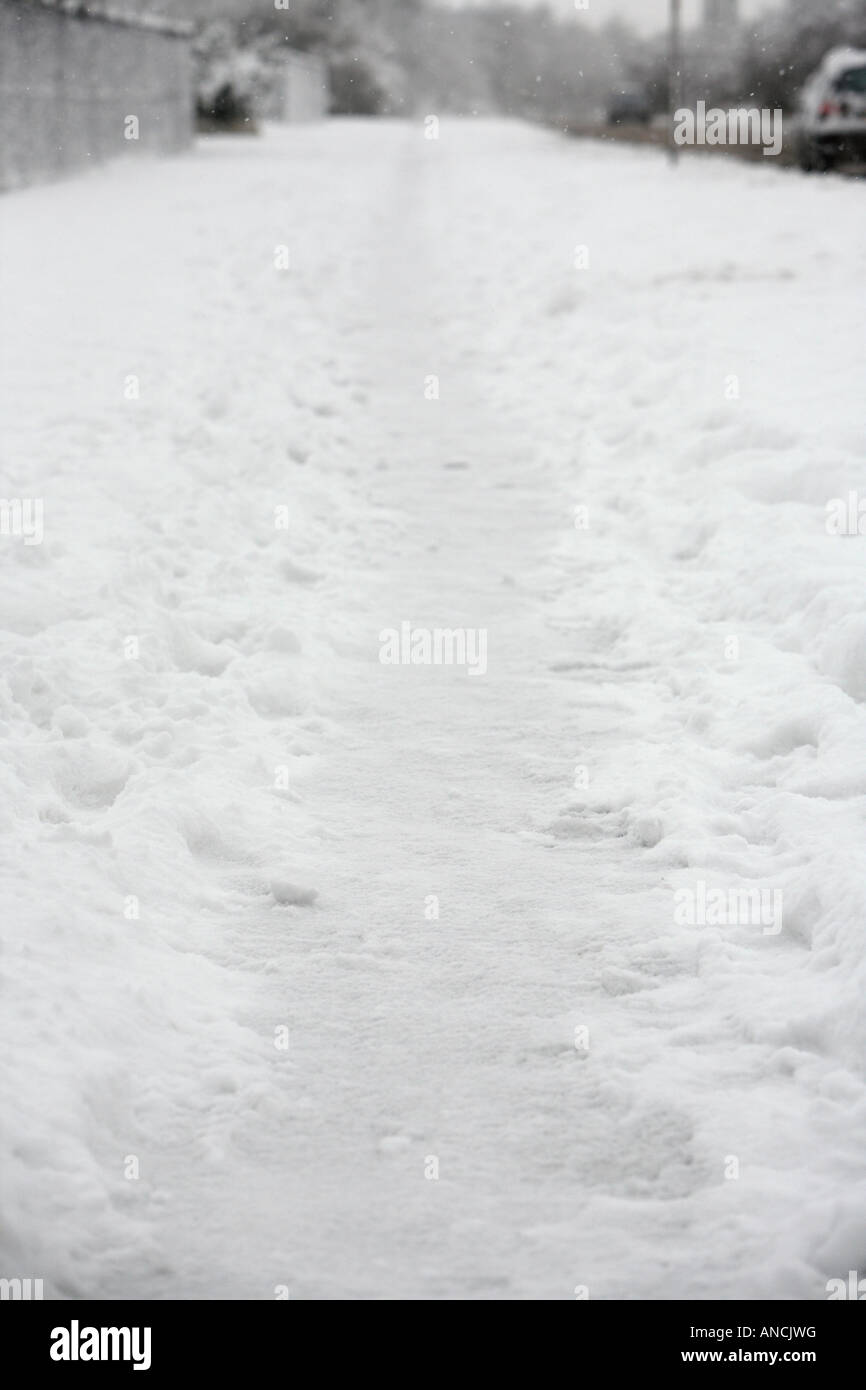 path worn through the snow on footpath creating icy path with ...