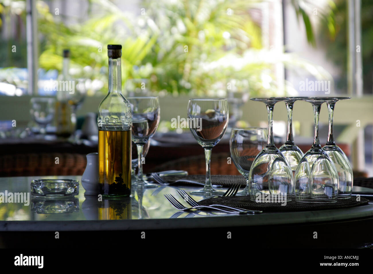 Table being laid in a restaurant in Barbados Stock Photo - Alamy
