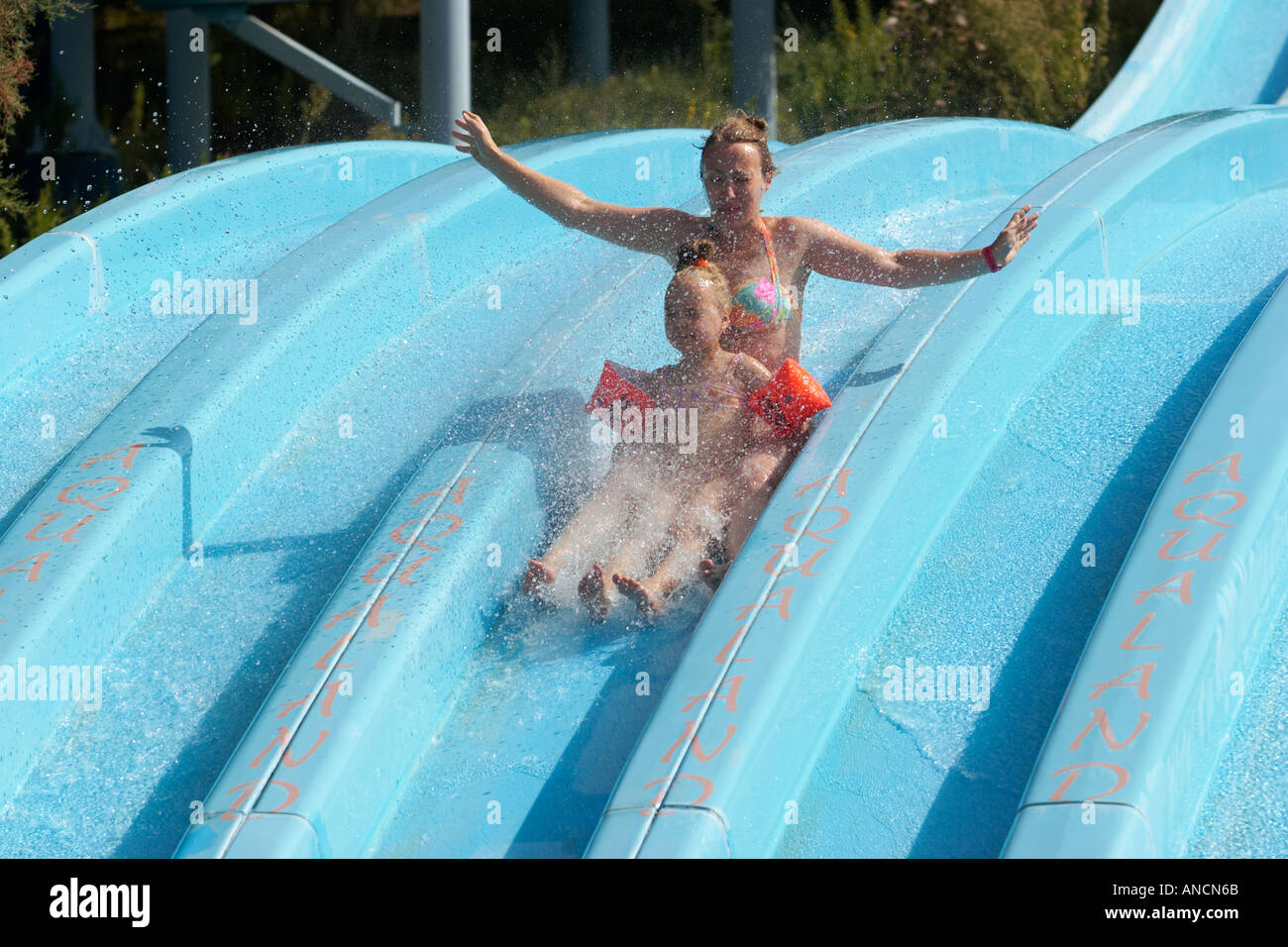 Mother and daughter watersliding together in Aqualand Water Park. Corfu ...