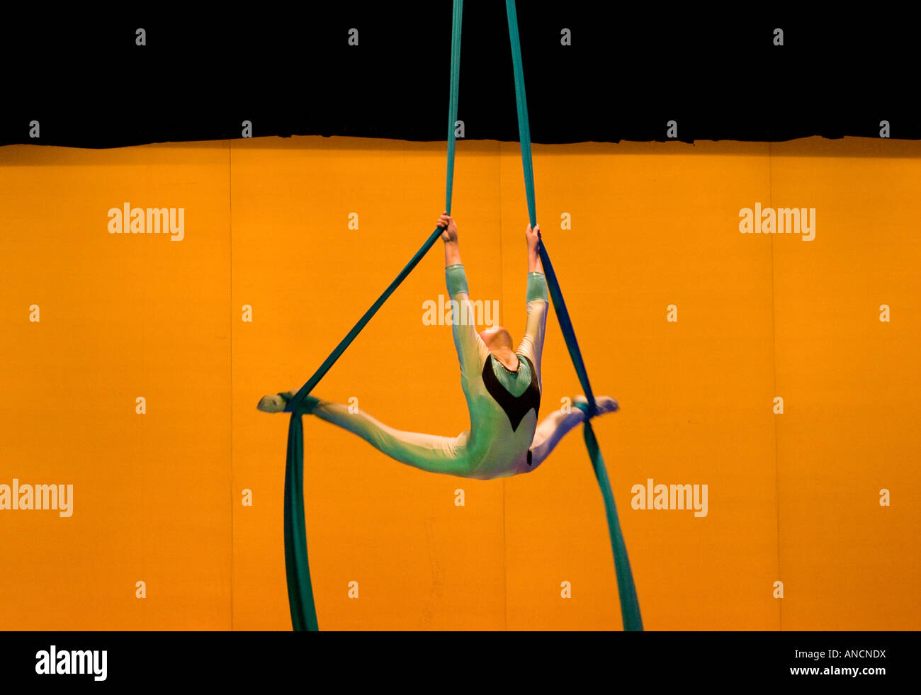 Acrobat doing a split in mid air Stock Photo - Alamy