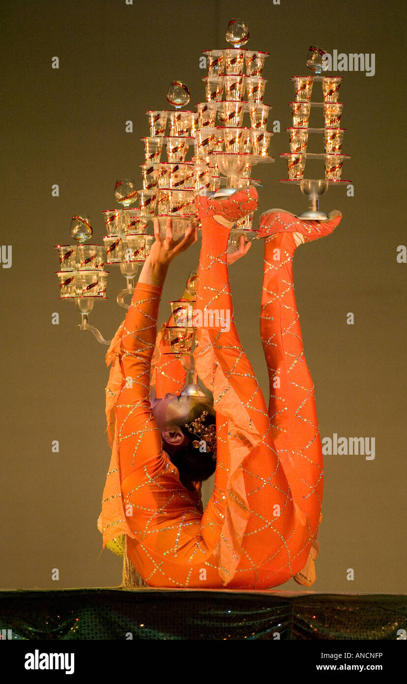 Chinese acrobat balancing glasses with her body Stock Photo - Alamy