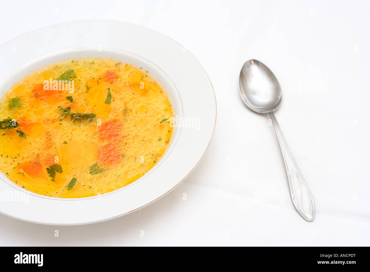 Spoon and some soup at a restaurant Stock Photo - Alamy