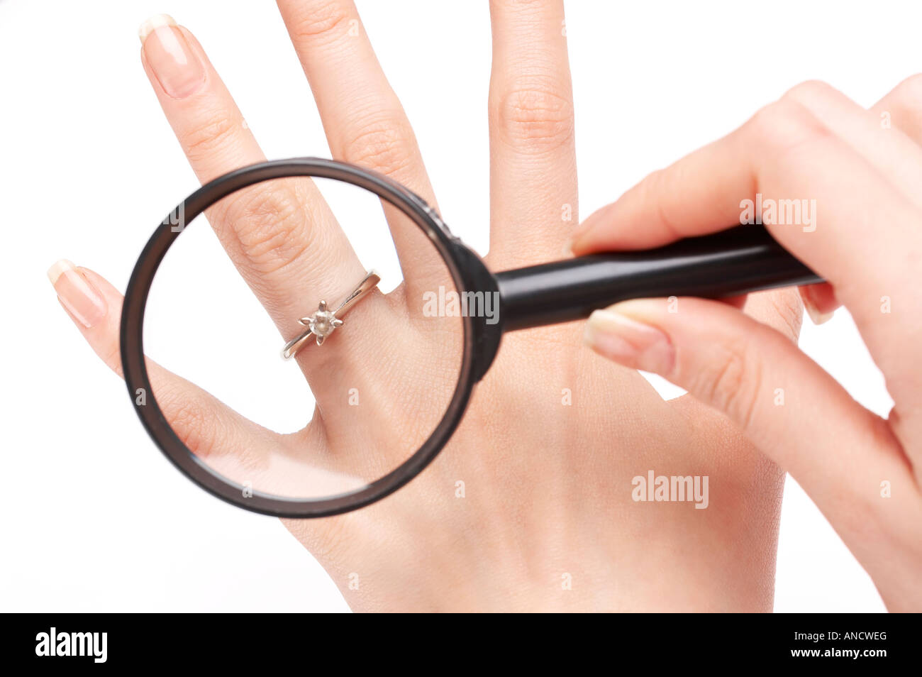 hand holding magnifying glass inspecting diamond ring Stock Photo - Alamy