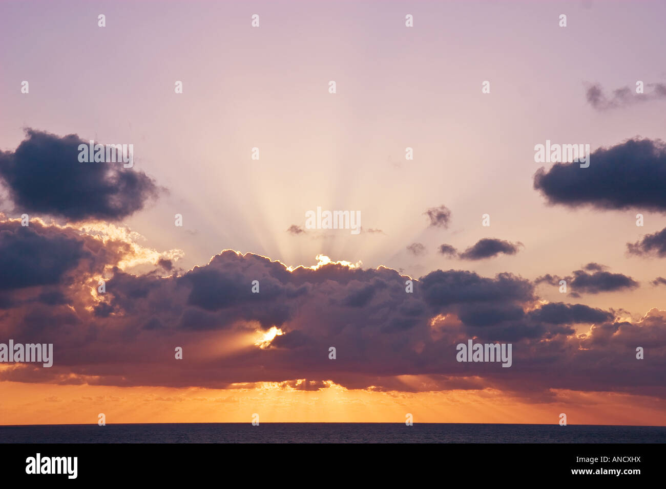 Sun rays peeking through clouds hi-res stock photography and images - Alamy