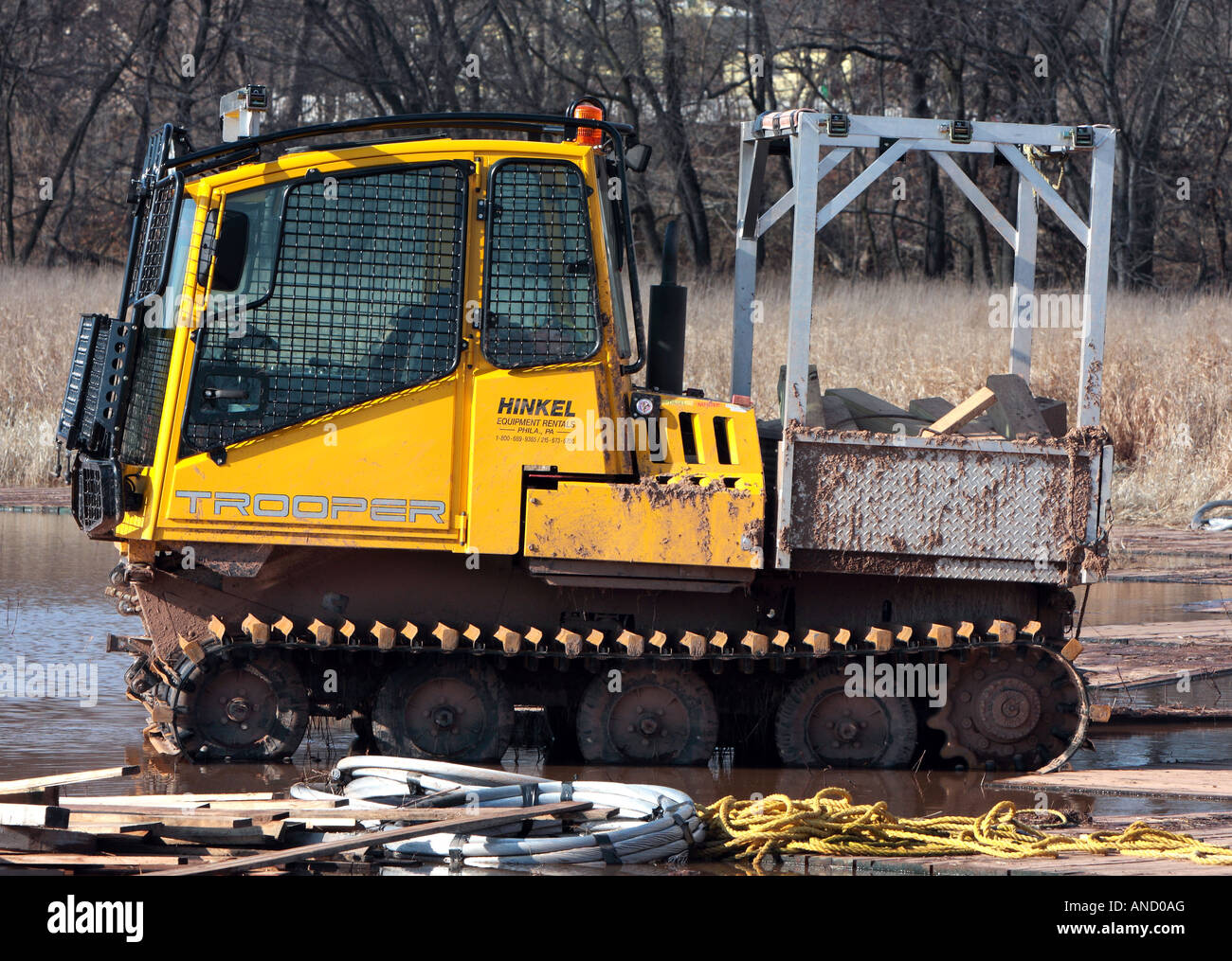 A tractor bulldozer at electrical power utility company's high tension ...