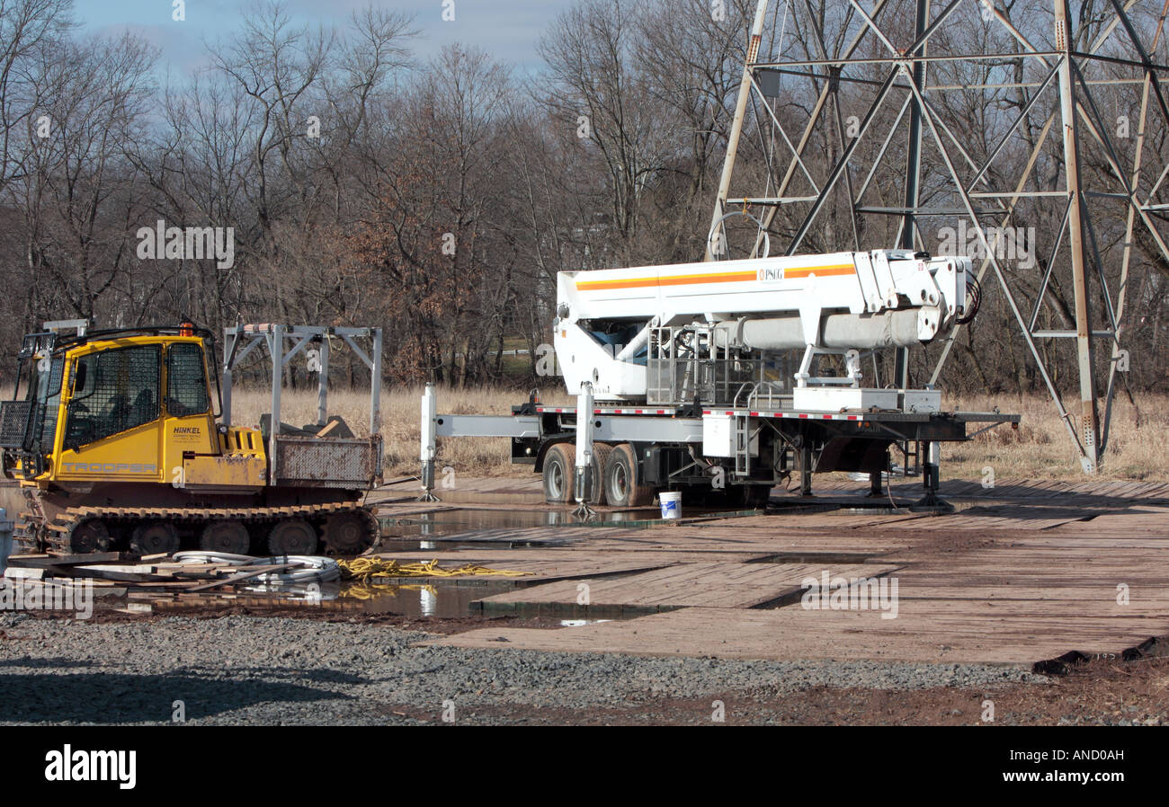 A electrical power utility company's high tension power line work site ...
