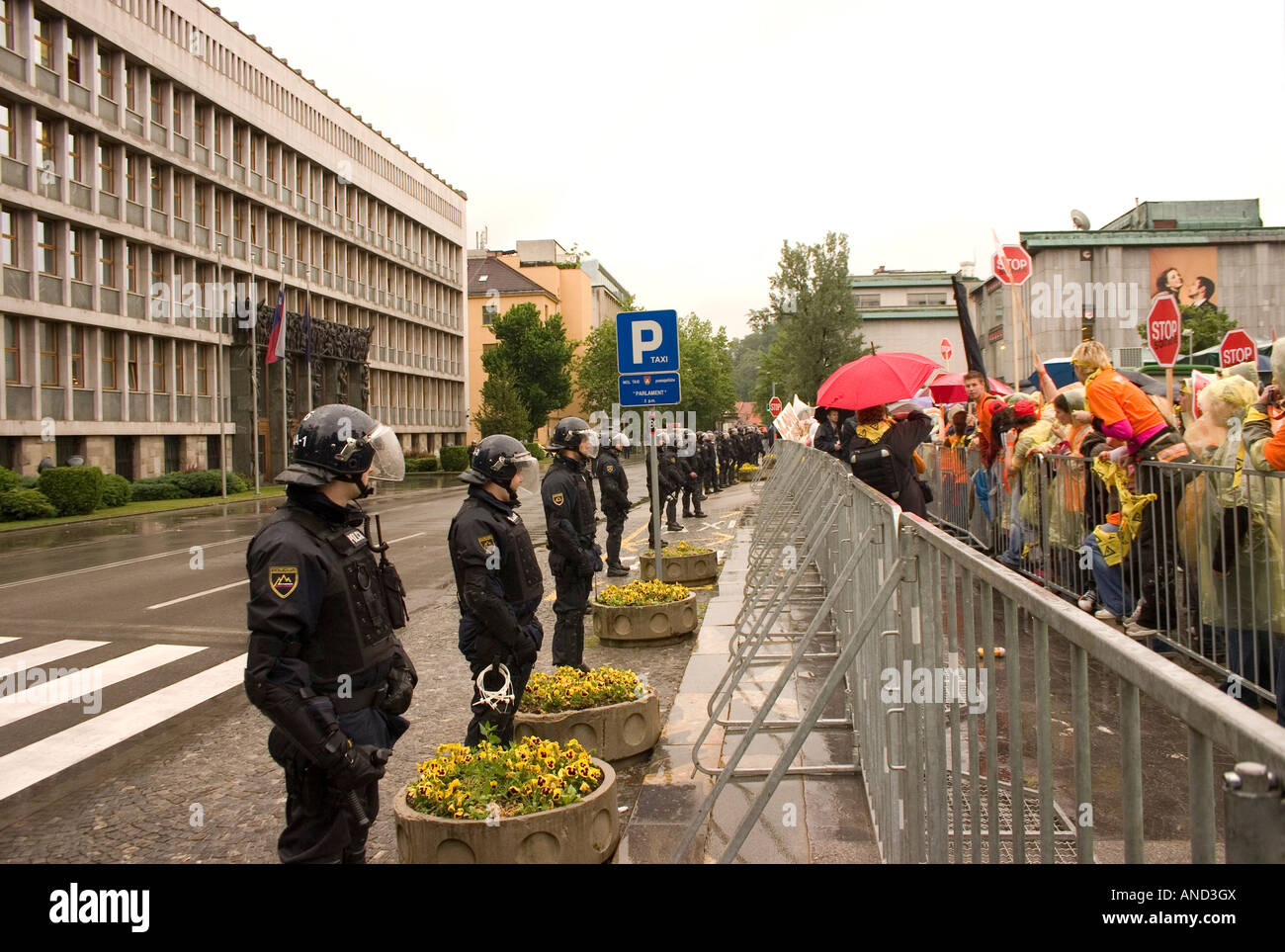 Police standing guard outside parliament while students protest against ...