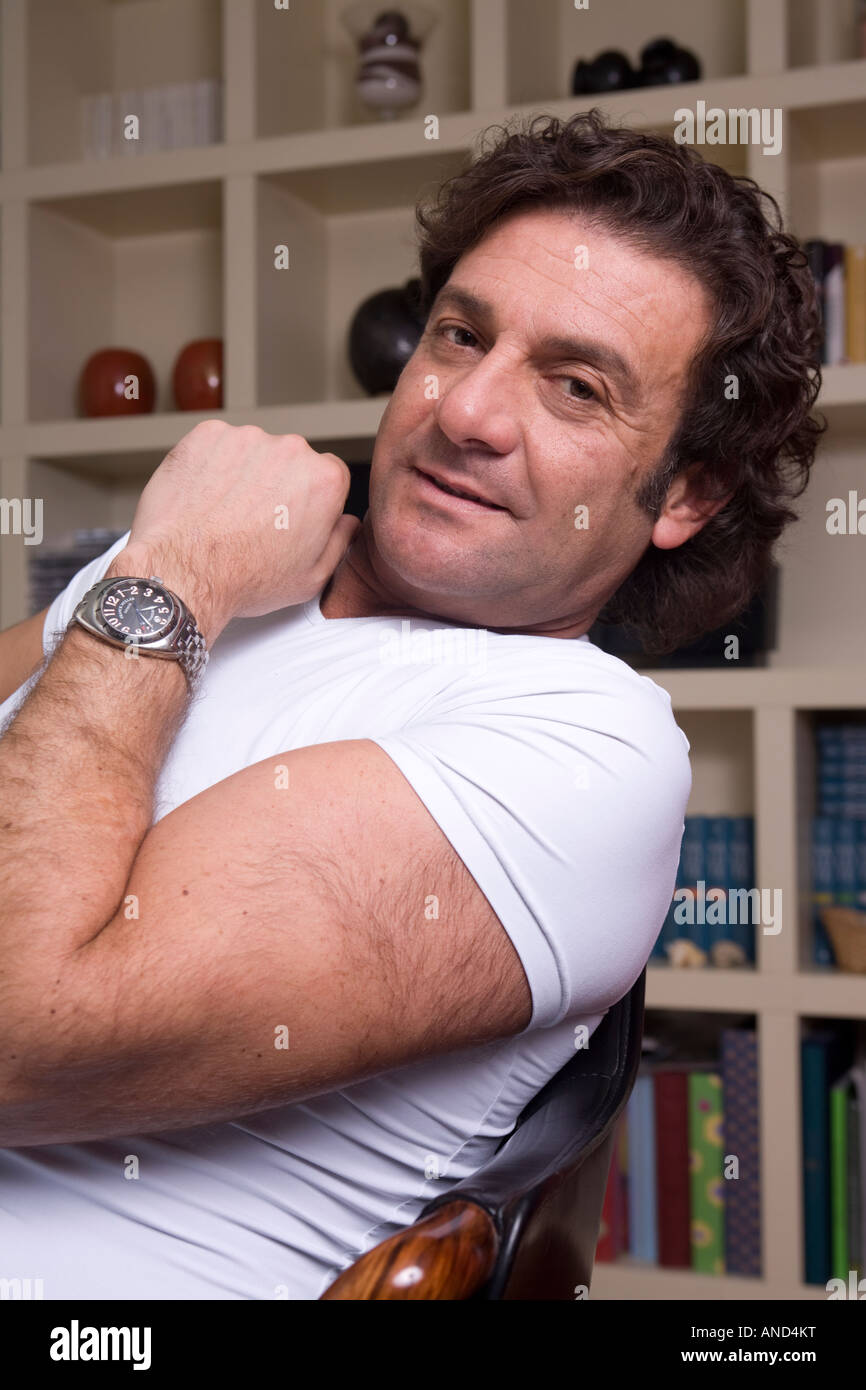 Successfull man showing muscles Stock Photo - Alamy