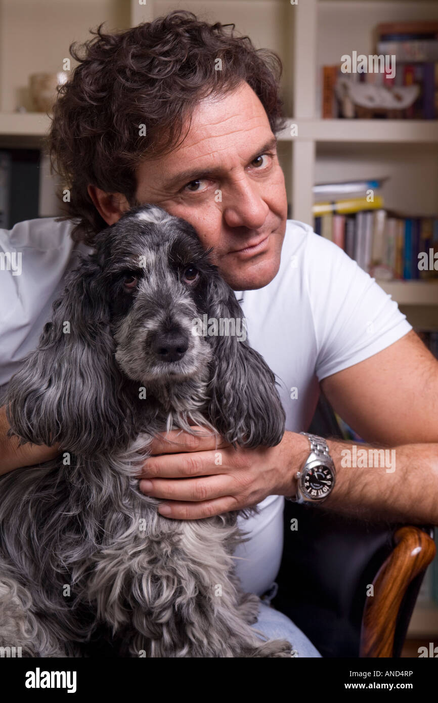 Man hugging his own dog indoor Stock Photo - Alamy