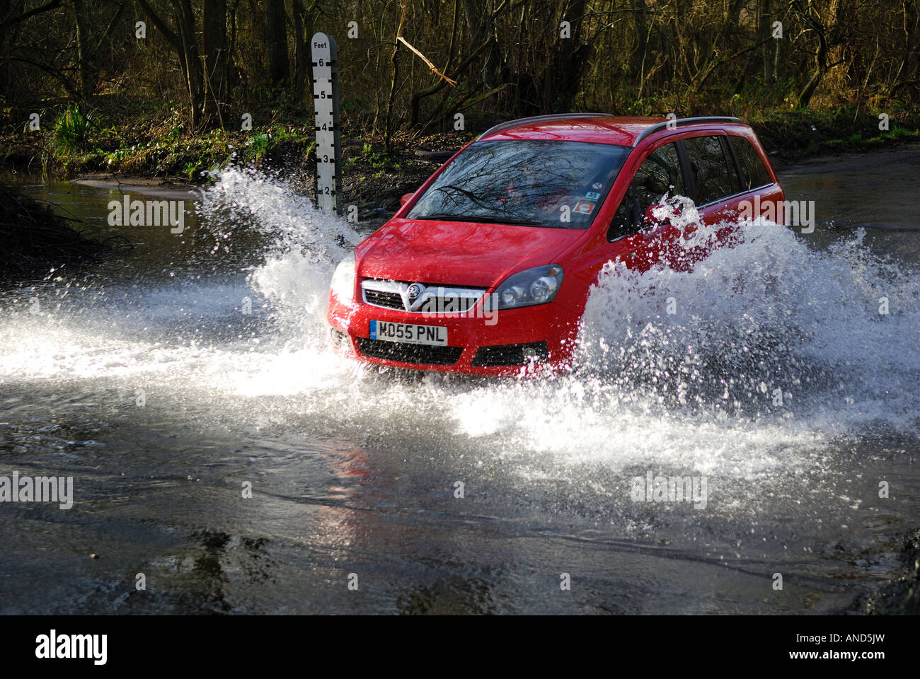 Car driving through ford Stock Photo - Alamy