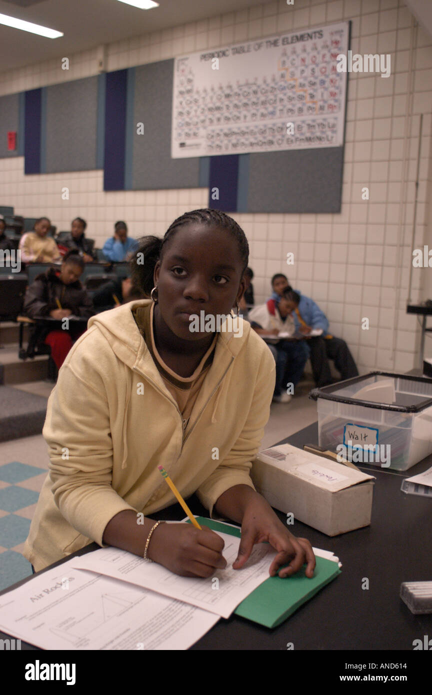 student with papers at desk in front of classroom Stock Photo - Alamy