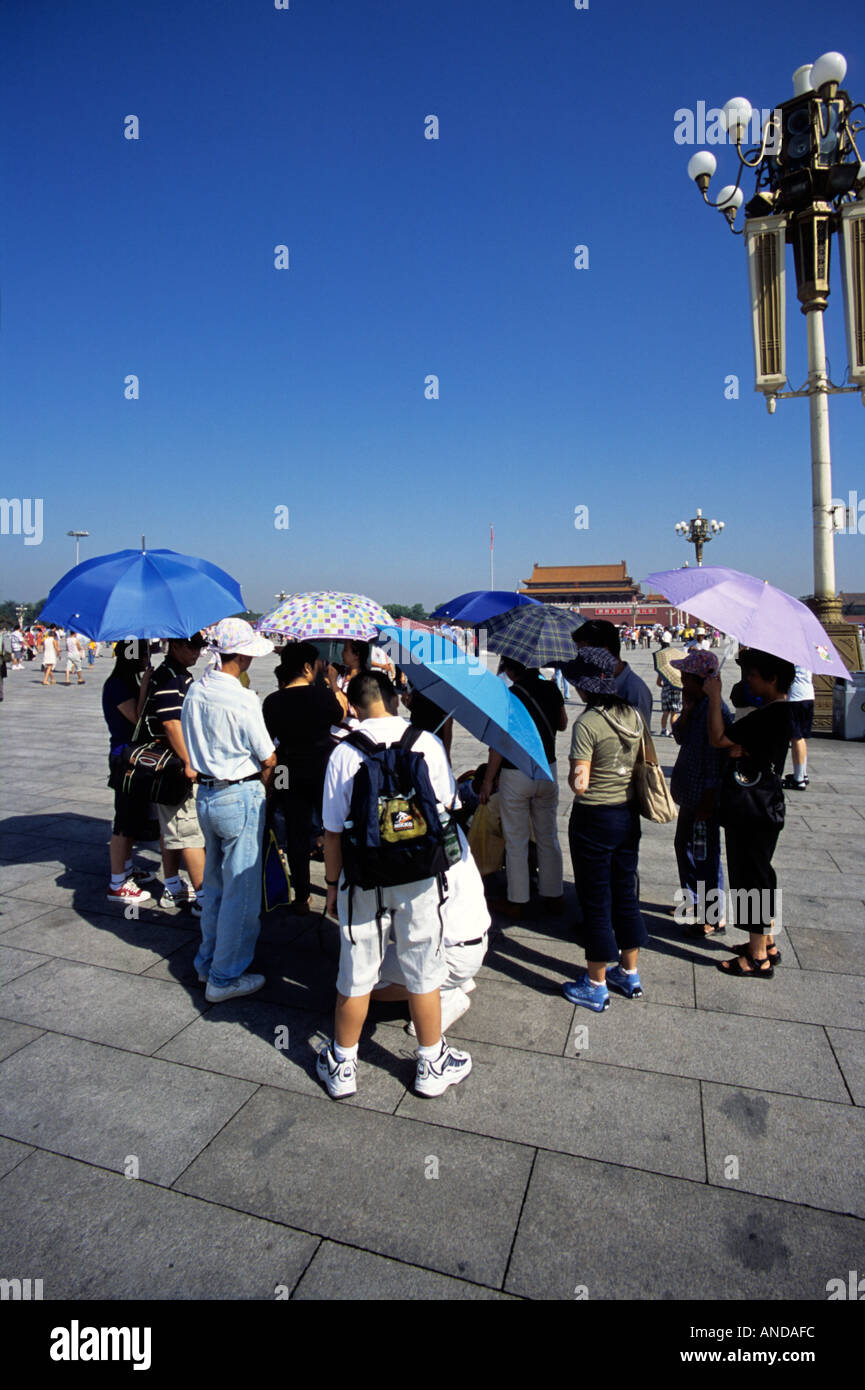 Japanese tourists keeping out of the sun on Tiananmen Square China ...