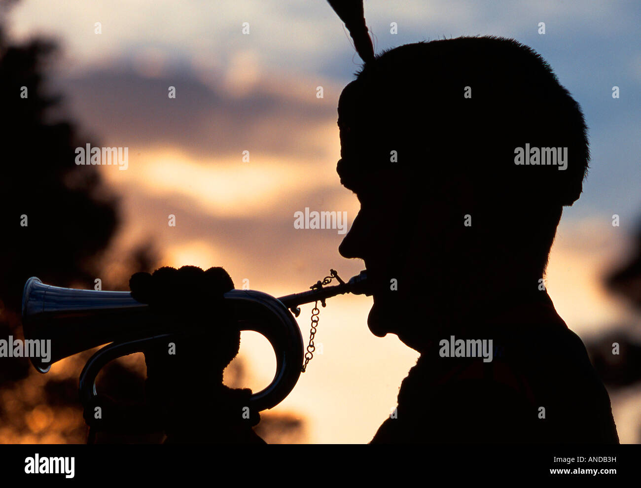Silhouette of a man playing a bugle Stock Photo - Alamy